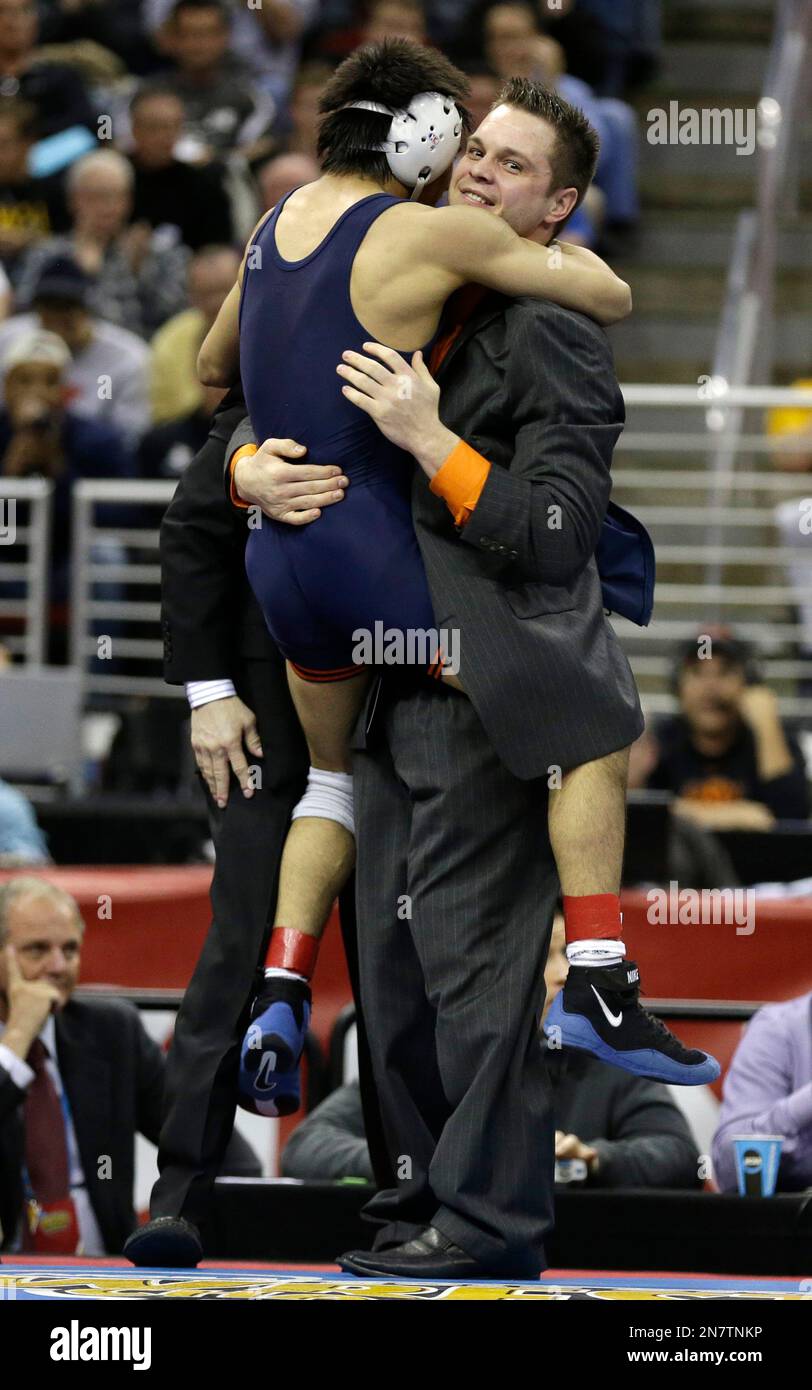 Illinois’ Jesse Delgado gets a hug from coach Mark Perry after beating ...