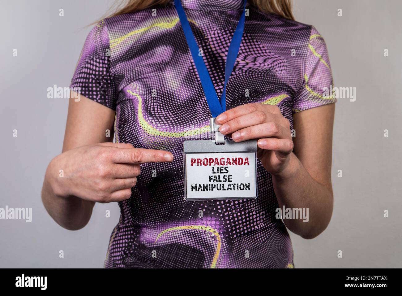 PROPAGANDA. LIES FALSE MANIPULATION. Business woman wearing id card ...