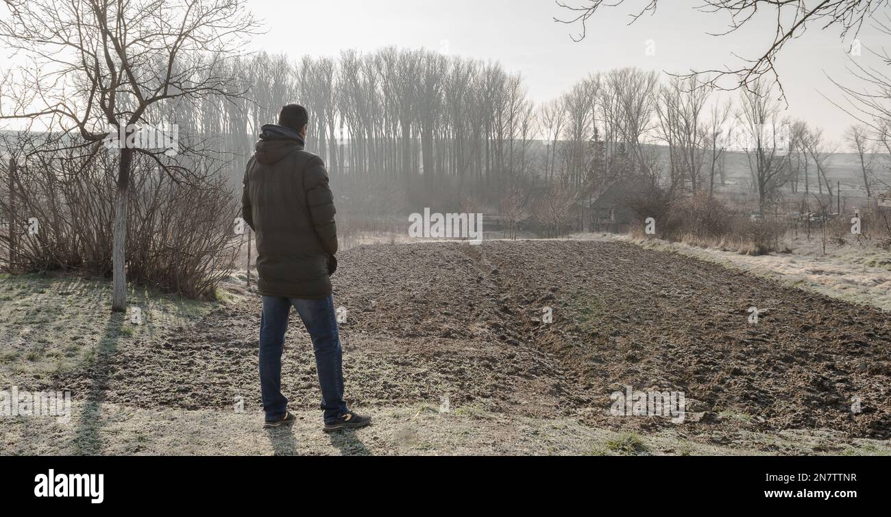 farmer looking at the land Stock Photo - Alamy