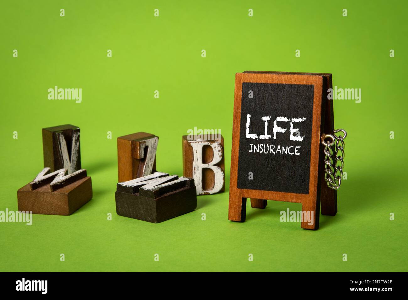 Life Insurance Concept. Miniature chalk board and alphabet letters on ...