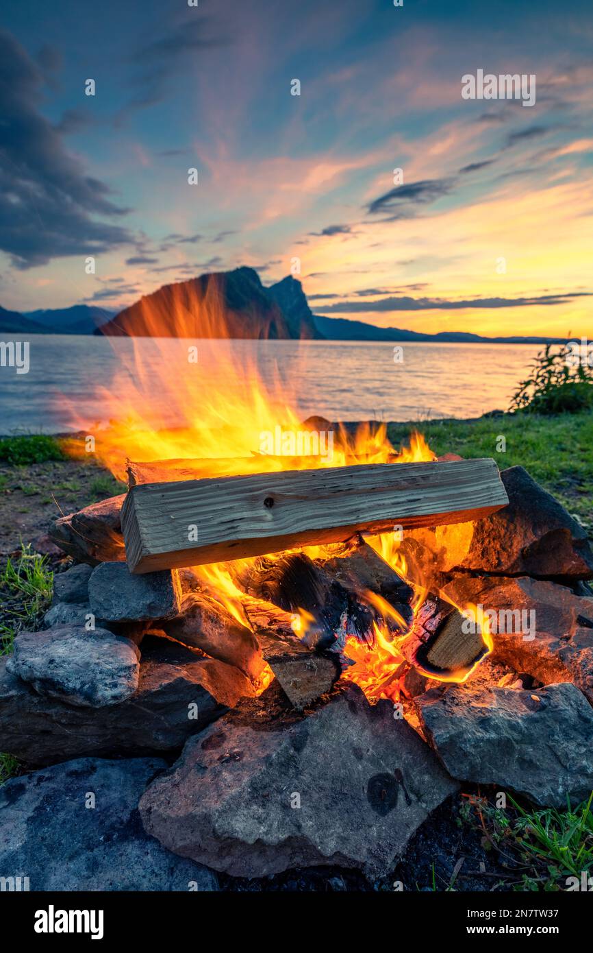 A fire on the lake during the sunset Stock Photo - Alamy