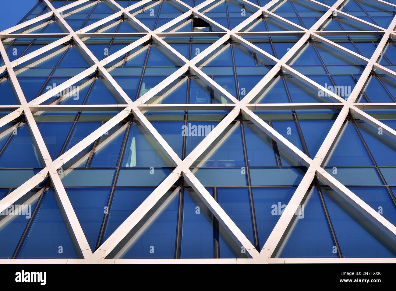 Glass modern building with blue sky background. Low angle view and ...