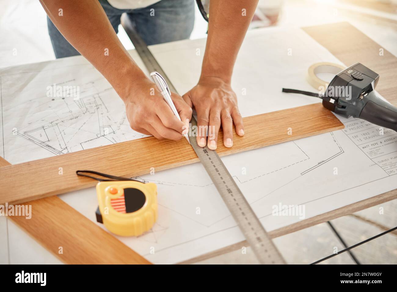 Not a centimetre off. an unrecognisable construction worker standing ...