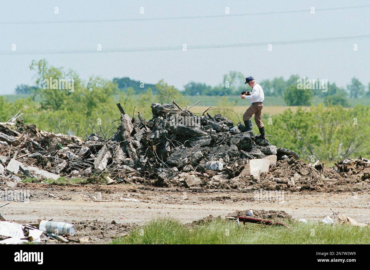 An unidentified official stands on some of the rubble of the Branch ...