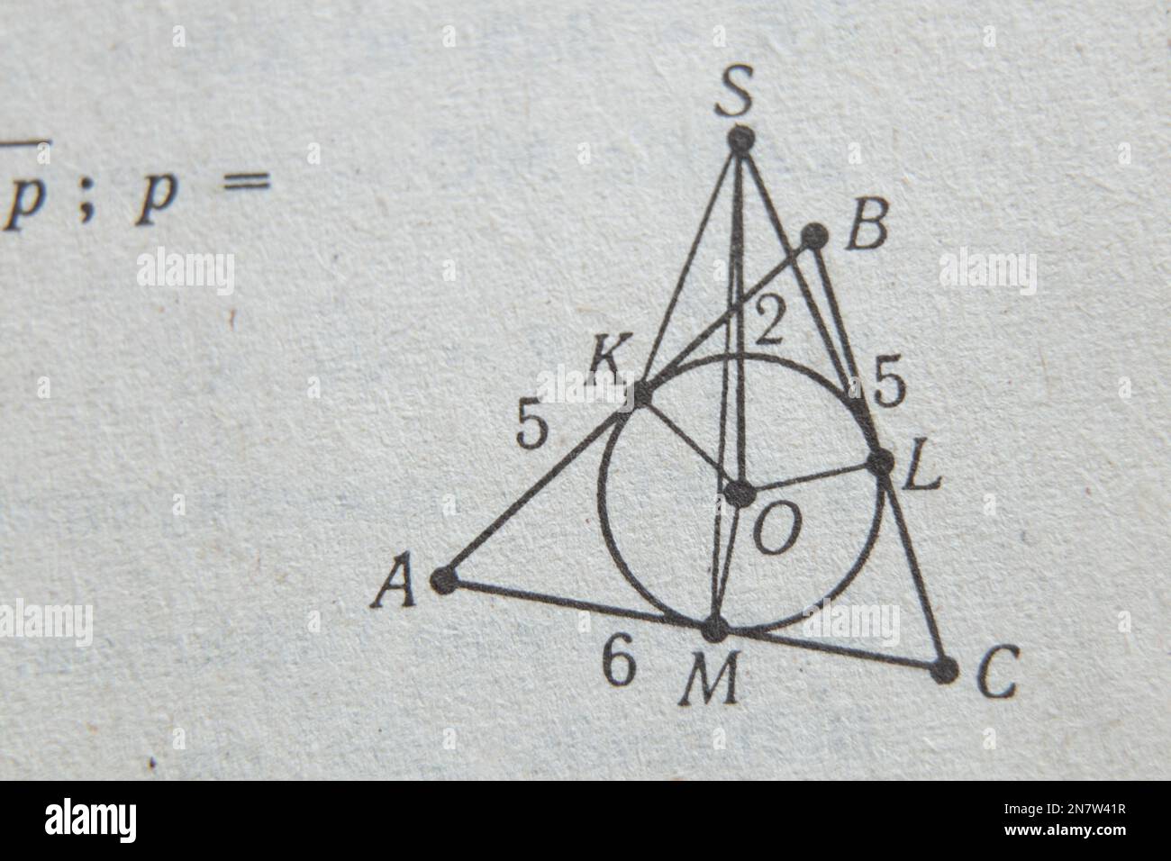geometry drawing on page of old yellow book as background, algebra book ...