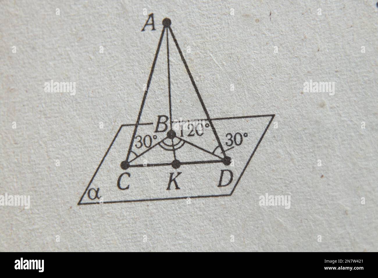 geometry drawing on page of old yellow book as background, algebra book ...