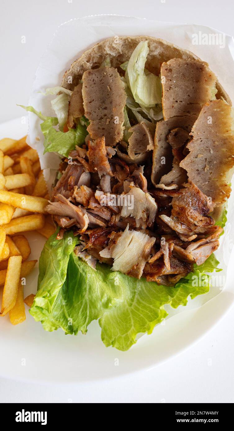 Close up of doner kebab with french fries isolated on white background ...