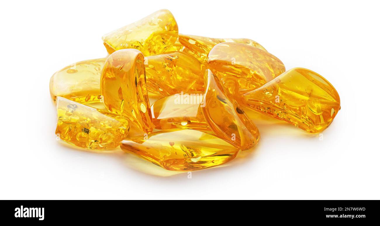 Transparent polished pieces of yellow amber on a white background. Sun ...