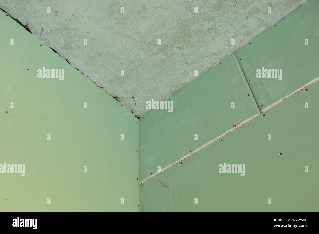 green plasterboard wall in a room during renovation, renovation of an ...