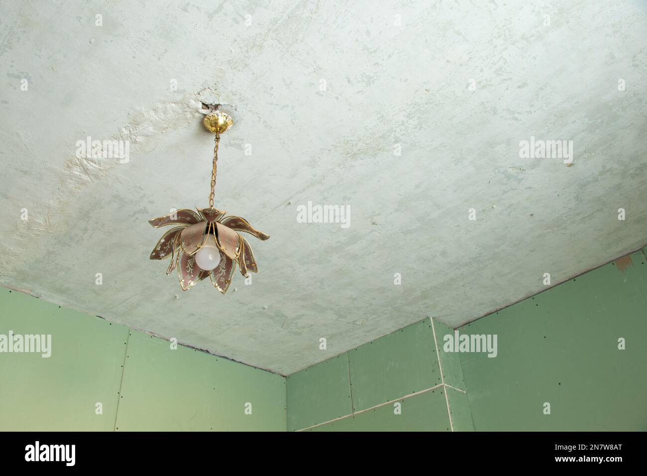 green plasterboard wall in the room during renovation and on the ...