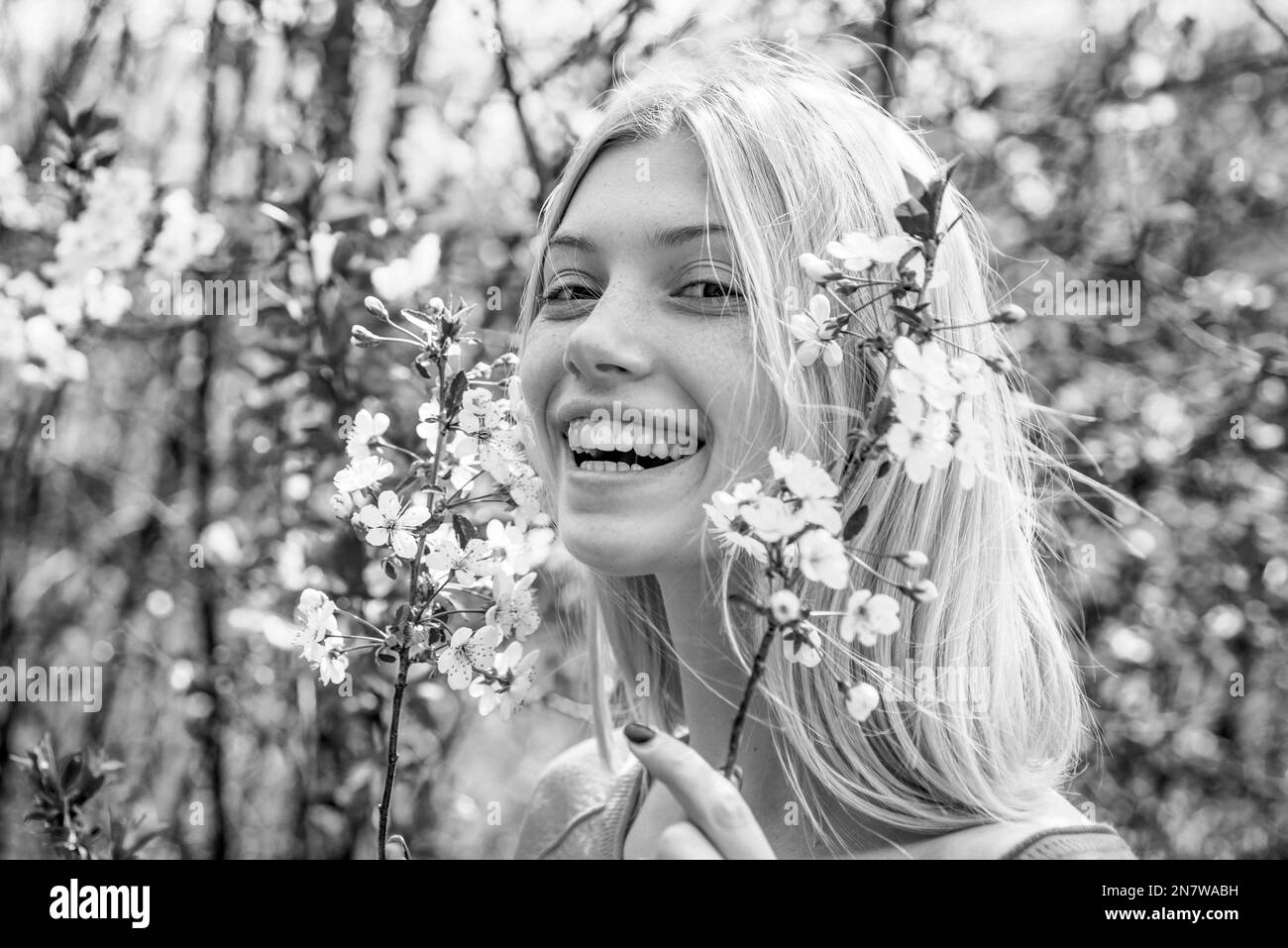 Happy Woman with branch spring flowers. Concept of happy women on ...