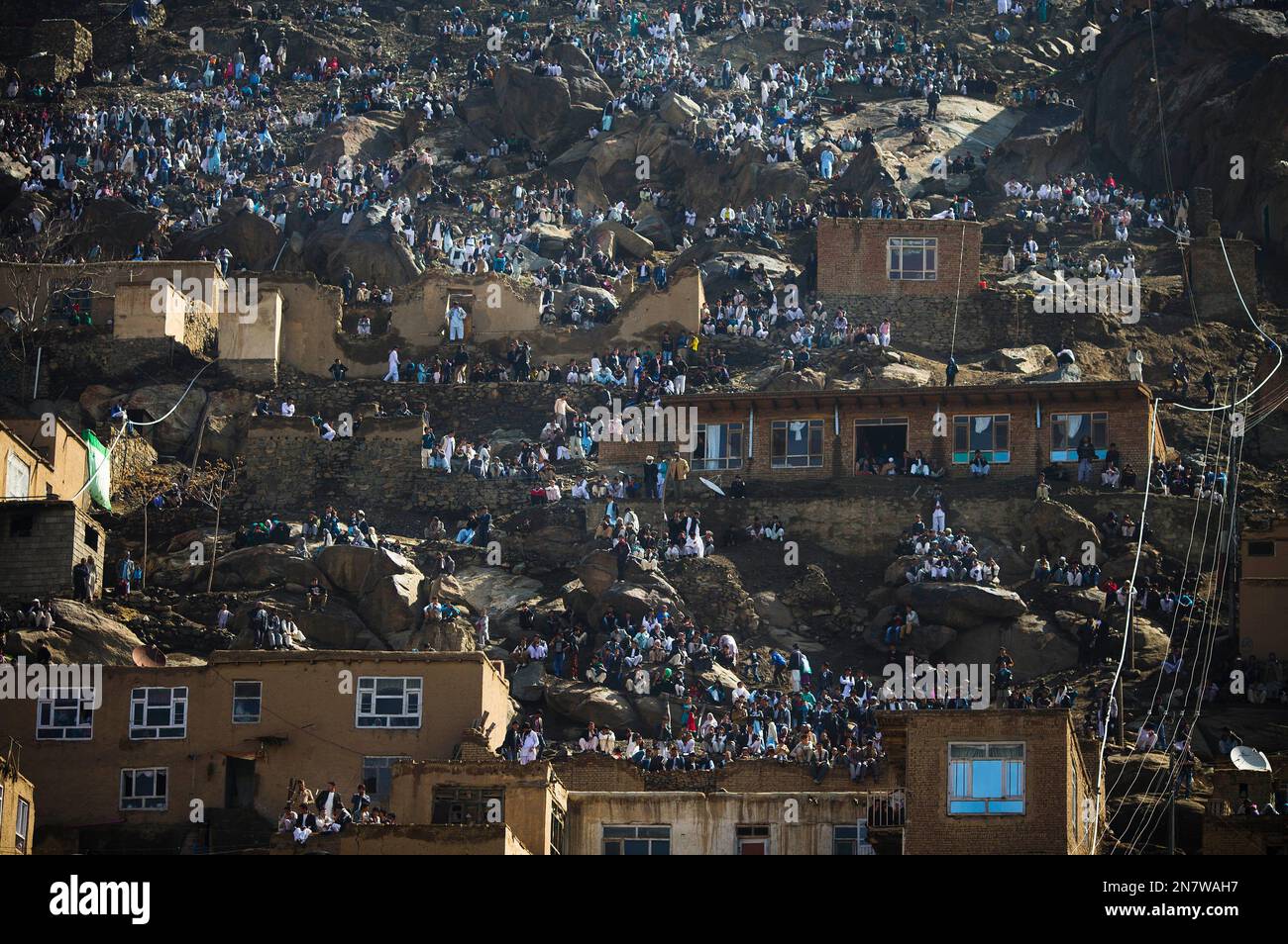 Hundreds of Afghans line up the hill overlooking the Kart-e Sakhi ...