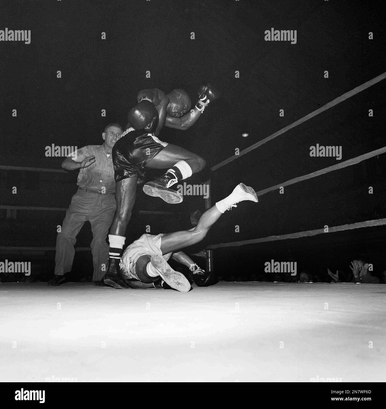 Rubin "Hurricane" Carter leaps over his opponent, Johnny Torres, after ...