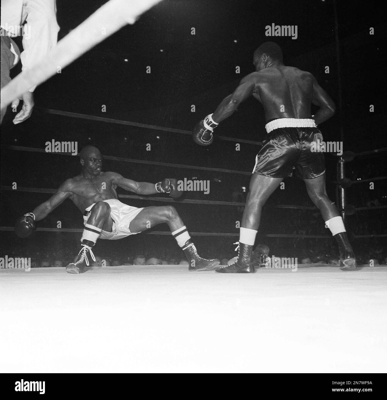 Nigeria's Dick Tiger sends Rubin "Hurricane" Carter to the ropes during ...