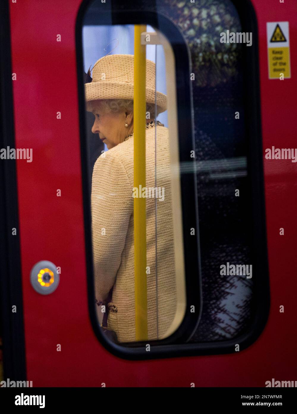 Britain's Queen Elizabeth II is shown round the carriage of a parked ...