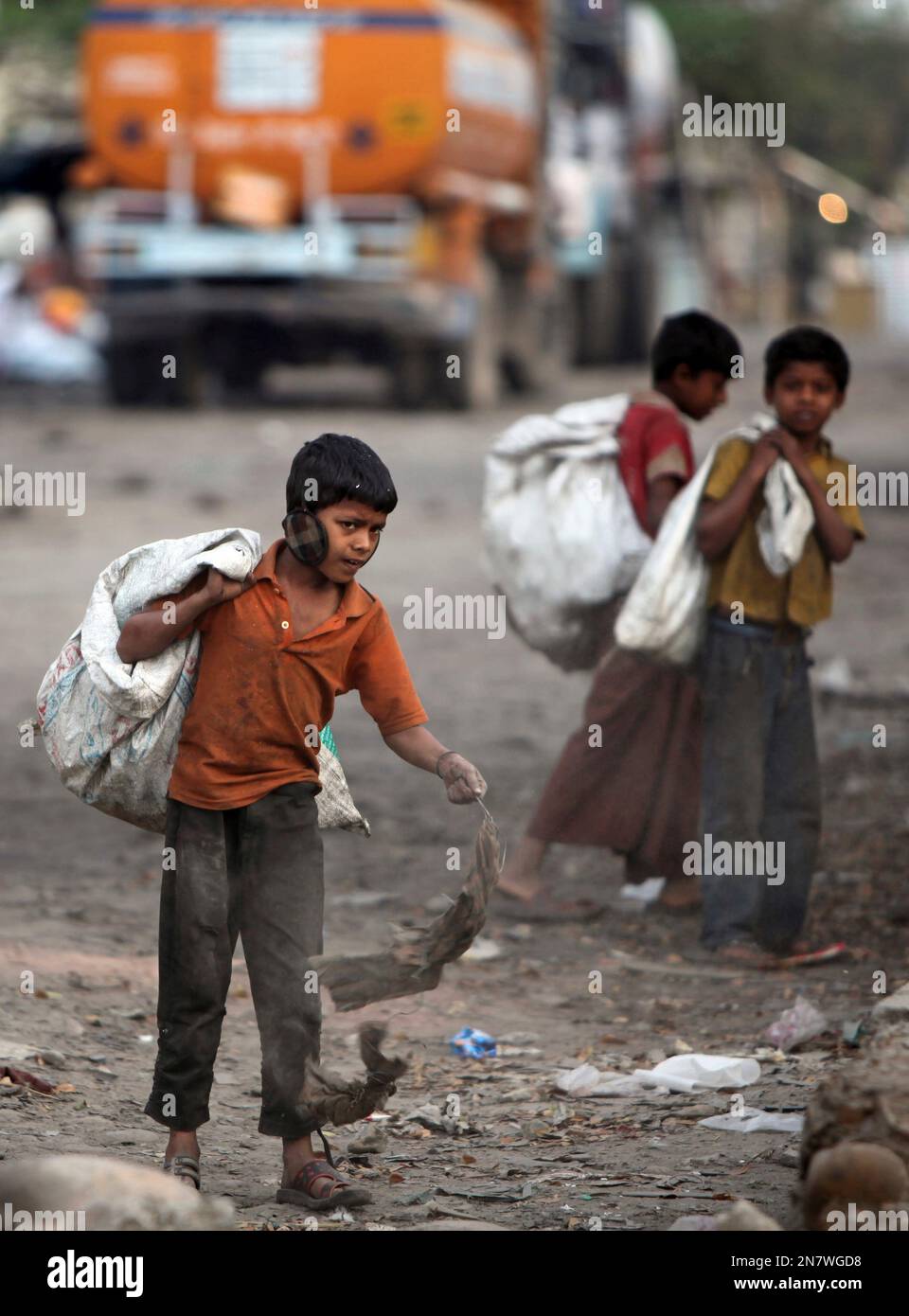 Indian ragpicker children look for recyclable spare parts at an ...