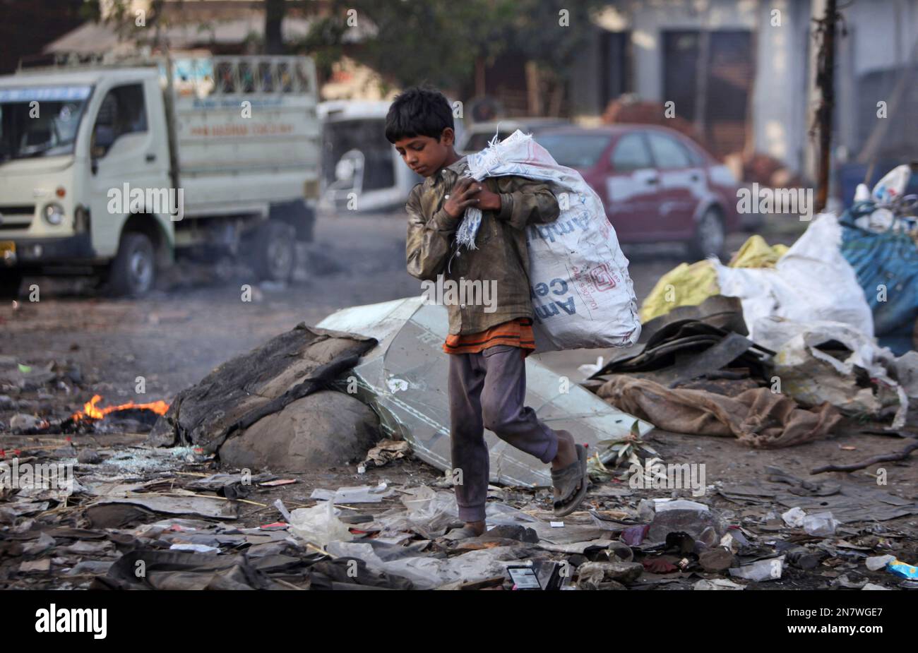 An Indian ragpicker boy looks for recyclable spare parts at an ...