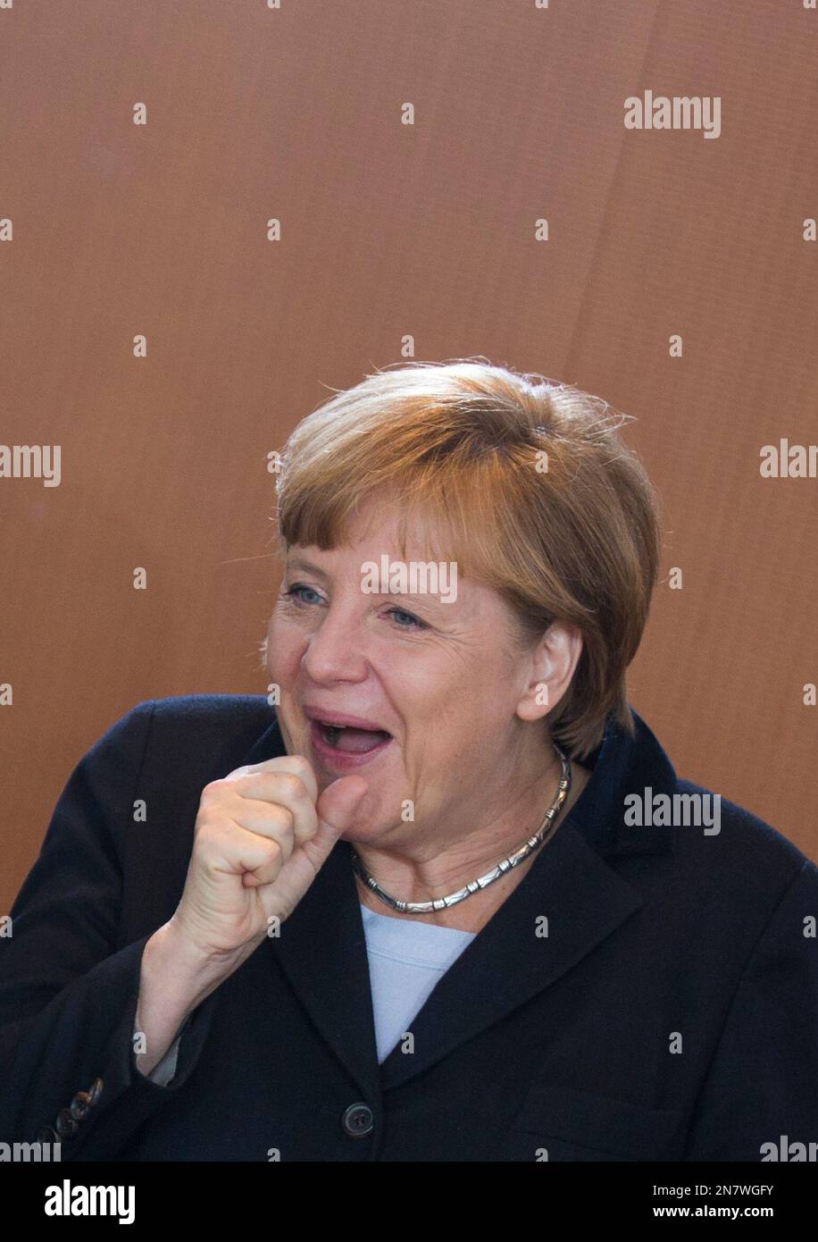 German Chancellor Angela Merkel laughs as she arrives for the weekly ...
