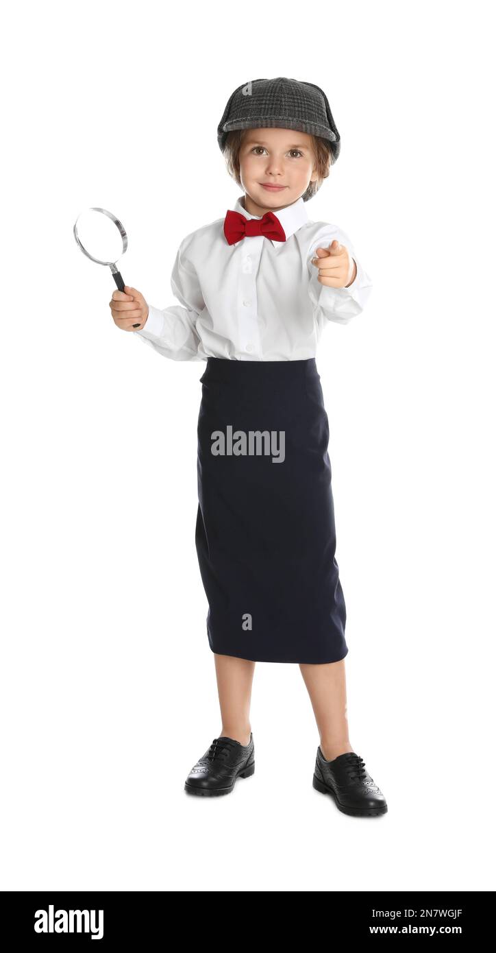 Cute little child in hat with magnifying glass playing detective on ...