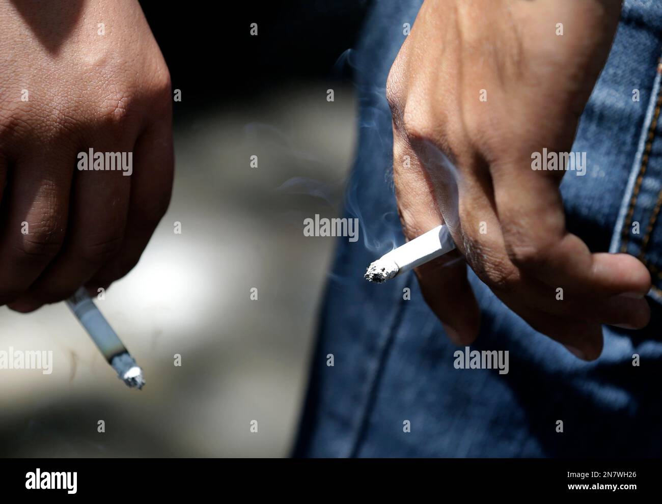 Filipino job applicants smoke while waiting for their documents to be ...