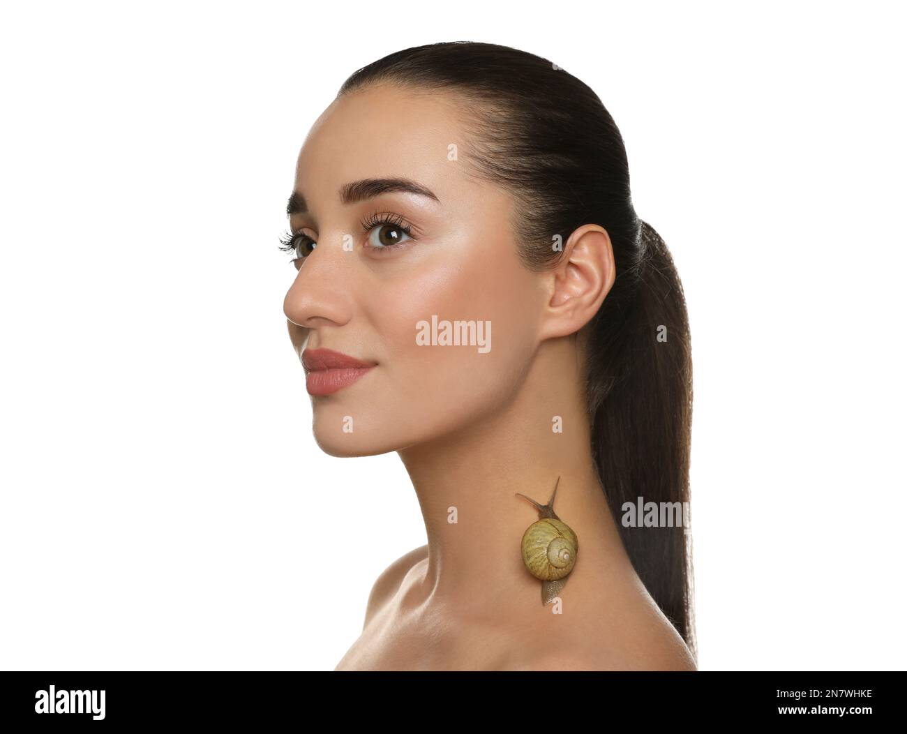 Beautiful young woman with snail on her neck against white background ...
