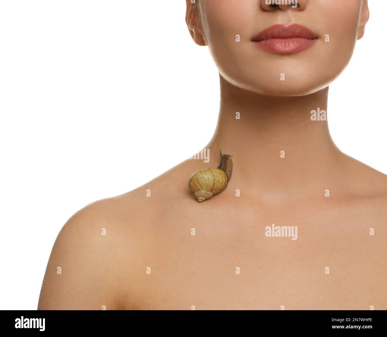 Beautiful young woman with snail on her body against white background ...