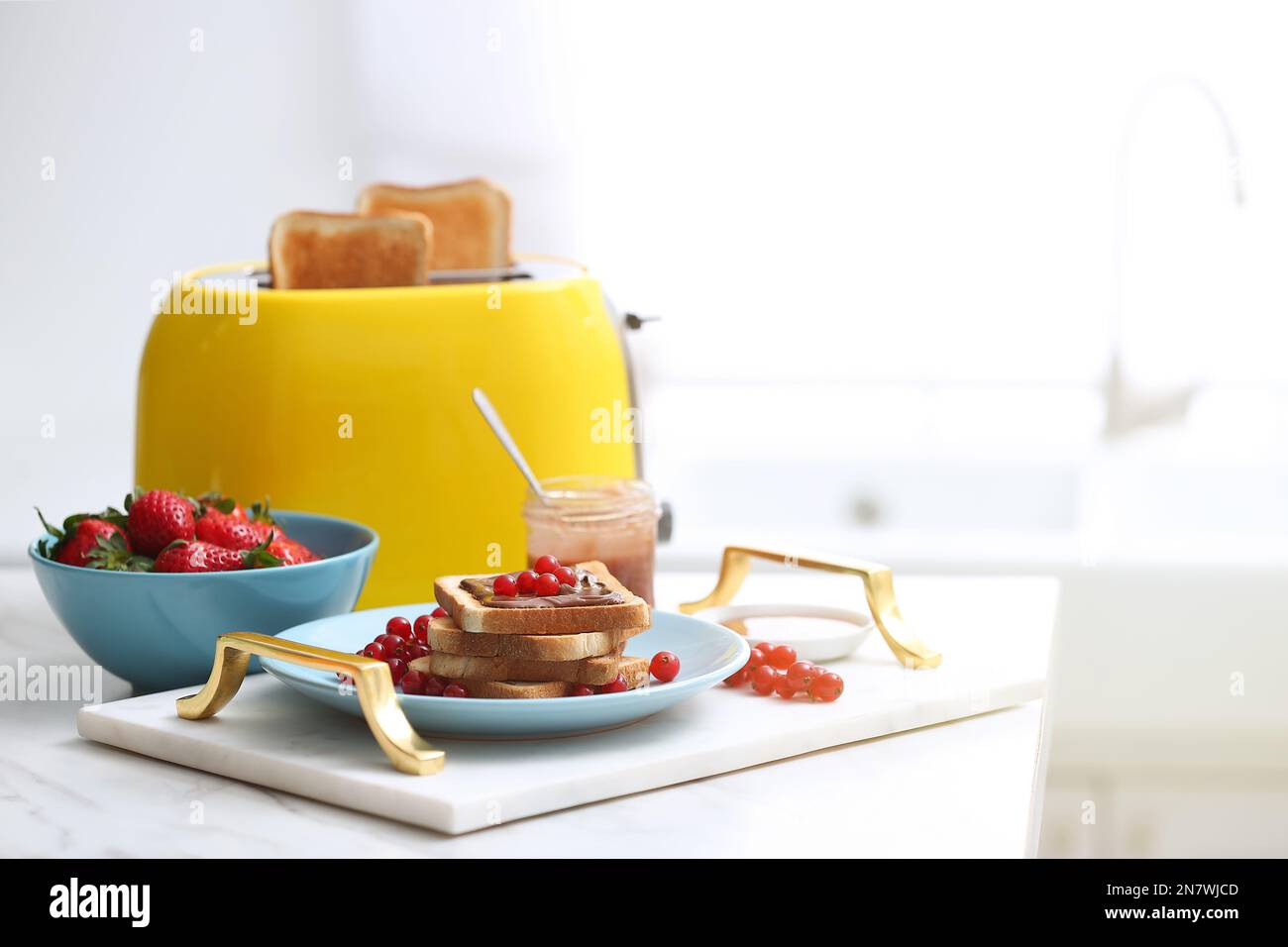 Toaster and sandwiches on white marble table in kitchen. Space for text ...
