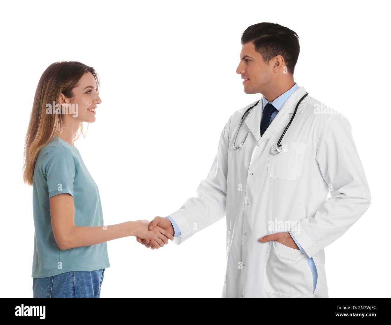 Doctor and patient shaking hands on white background Stock Photo - Alamy