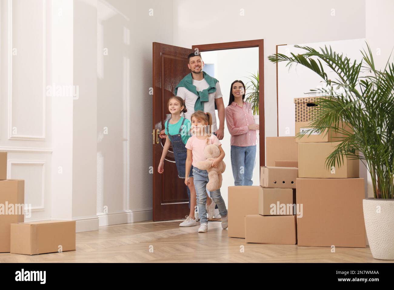 Happy family with children moving into new house Stock Photo - Alamy