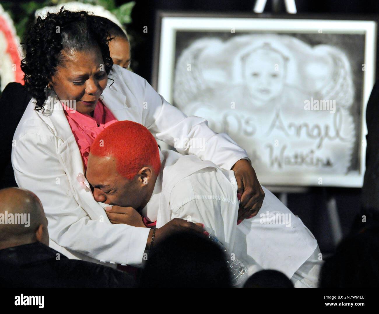 A family member is consoled before six-month old Jonylah Watkins ...