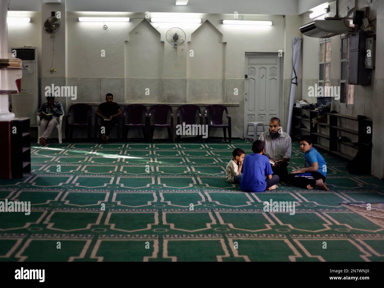 In this Sunday, March 17, 2013 photo, an Egyptian man teaches children ...