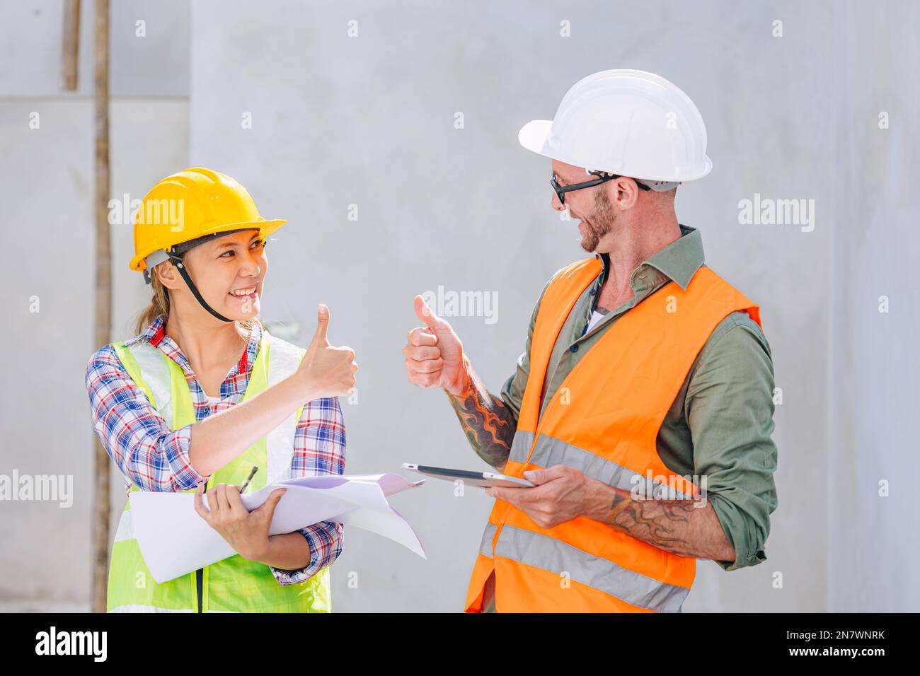 happy builder man and woman engineer construction worker working ...