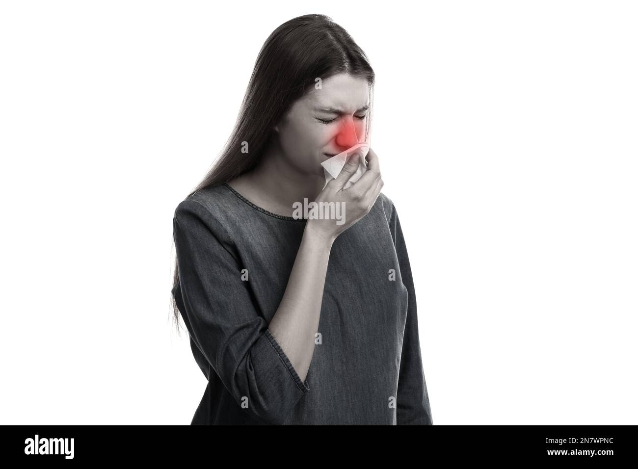 Young woman with tissue sneezing on light background, toned in black ...