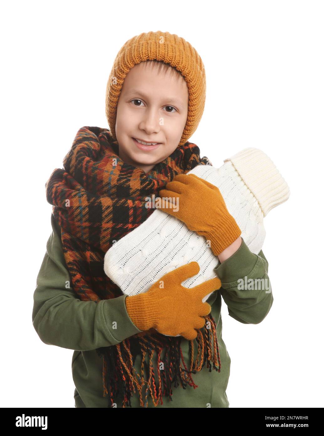 Ill boy with hot water bottle suffering from cold on white background ...