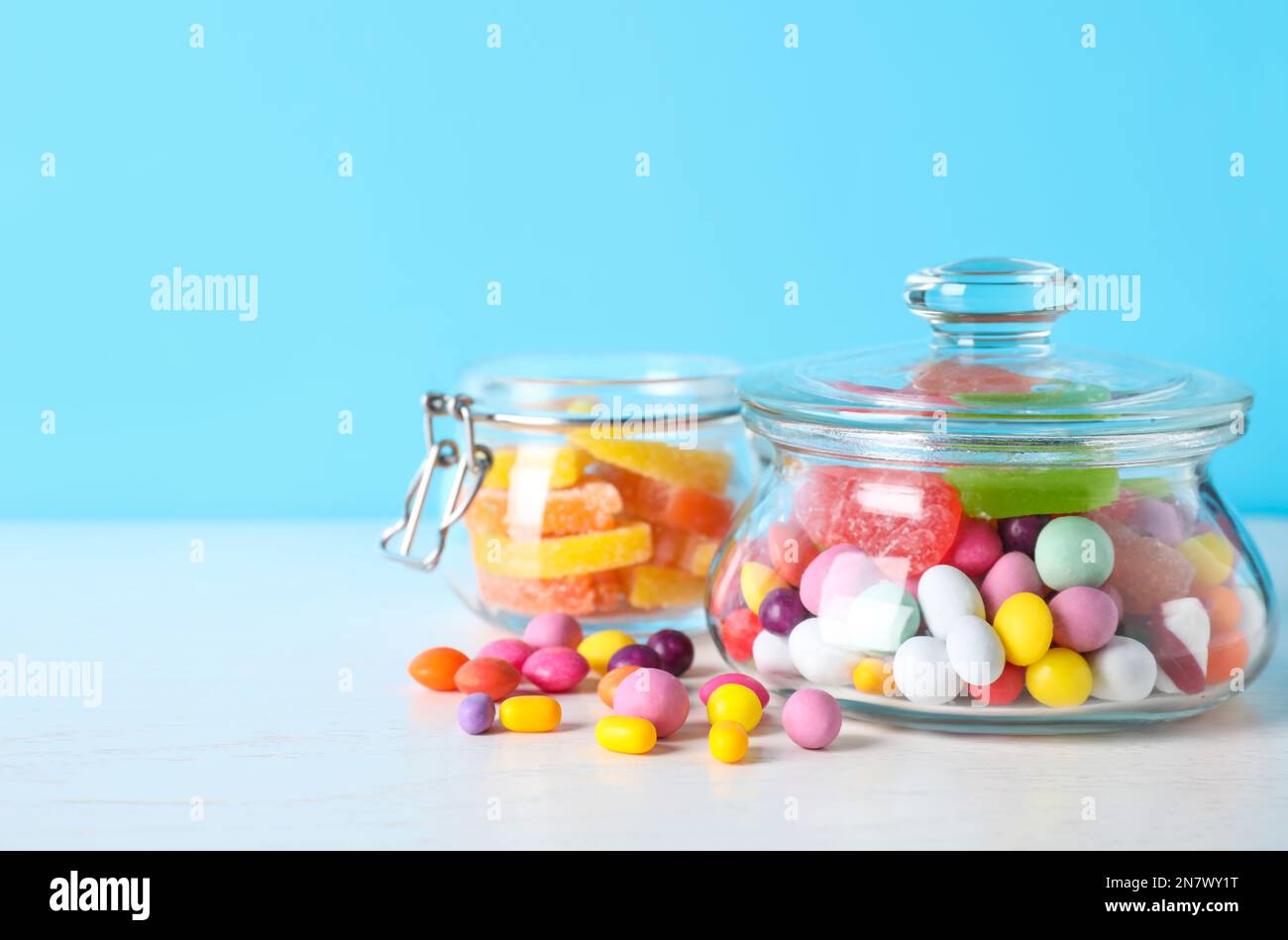Different yummy candies on light blue background. Space for text Stock ...