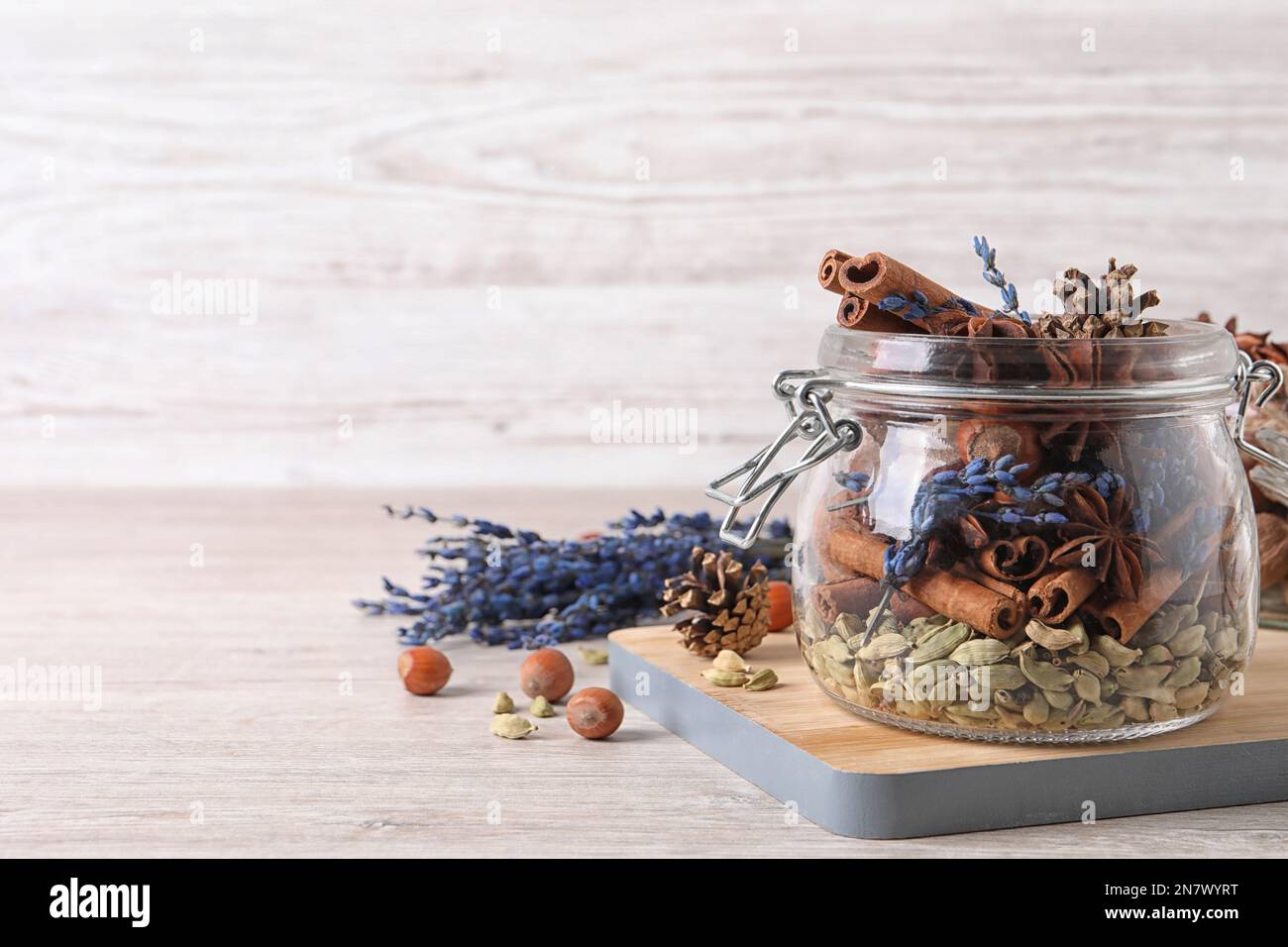 Aroma potpourri with different spices on white wooden table, space for ...