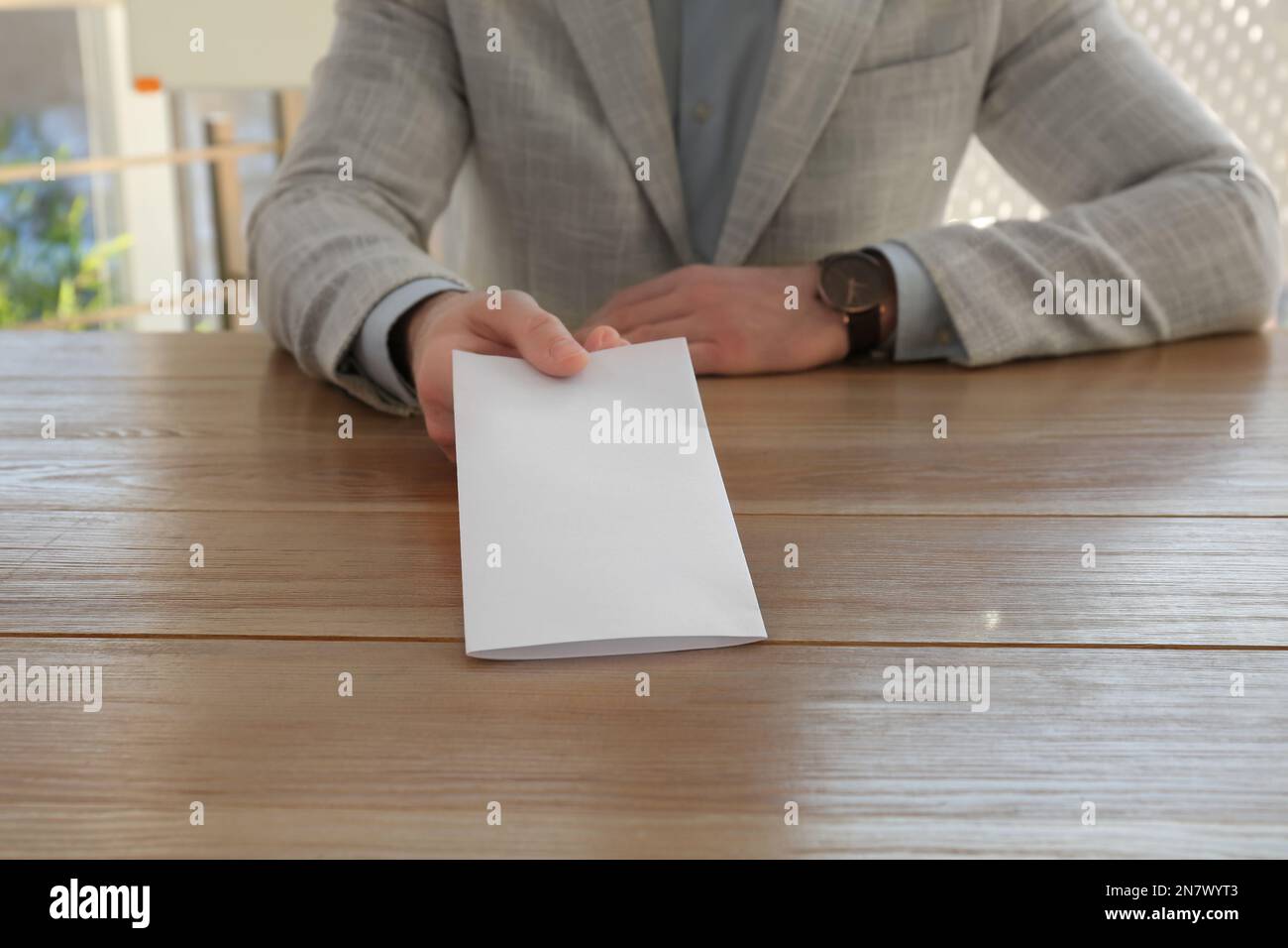 Employee with resignation letter at table in office, closeup Stock ...