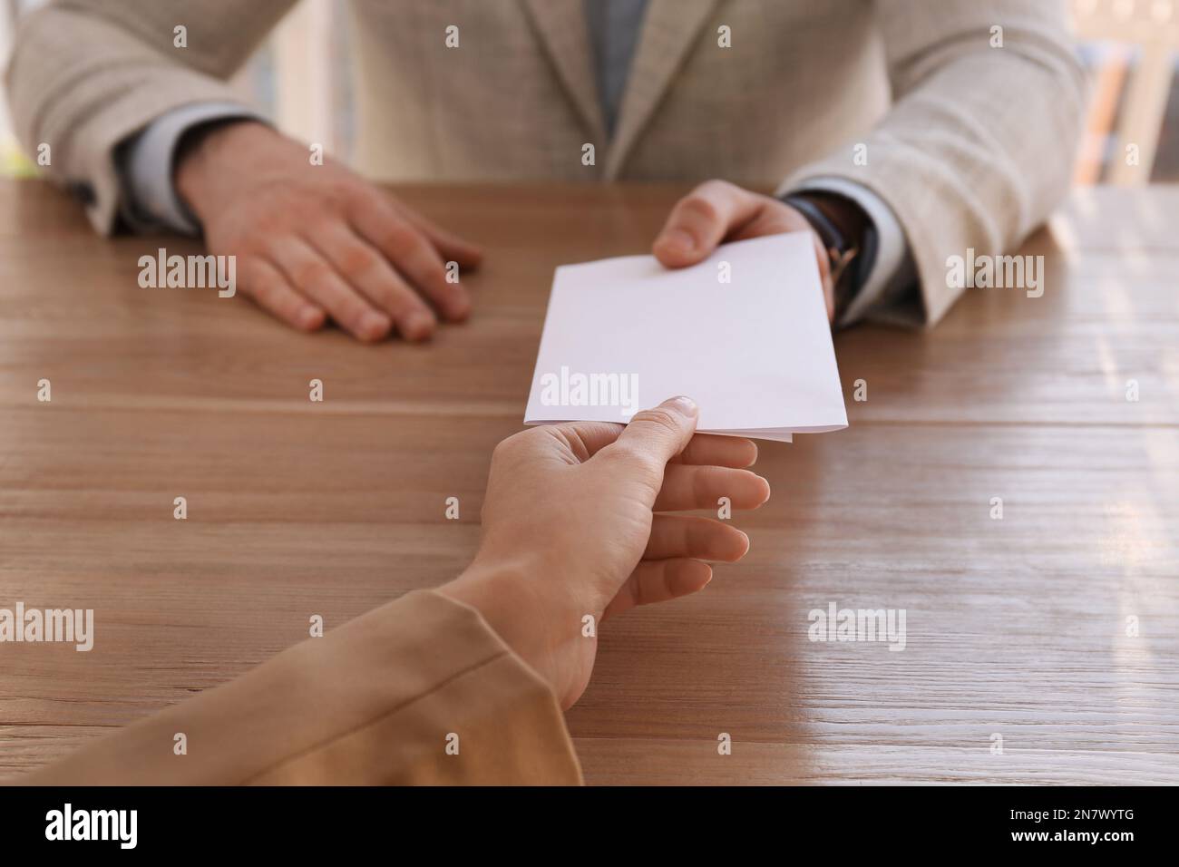 Employee giving resignation letter to boss in office, closeup Stock ...