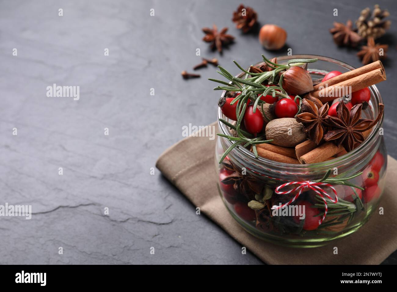 Aroma potpourri with different spices on black table, space for text ...