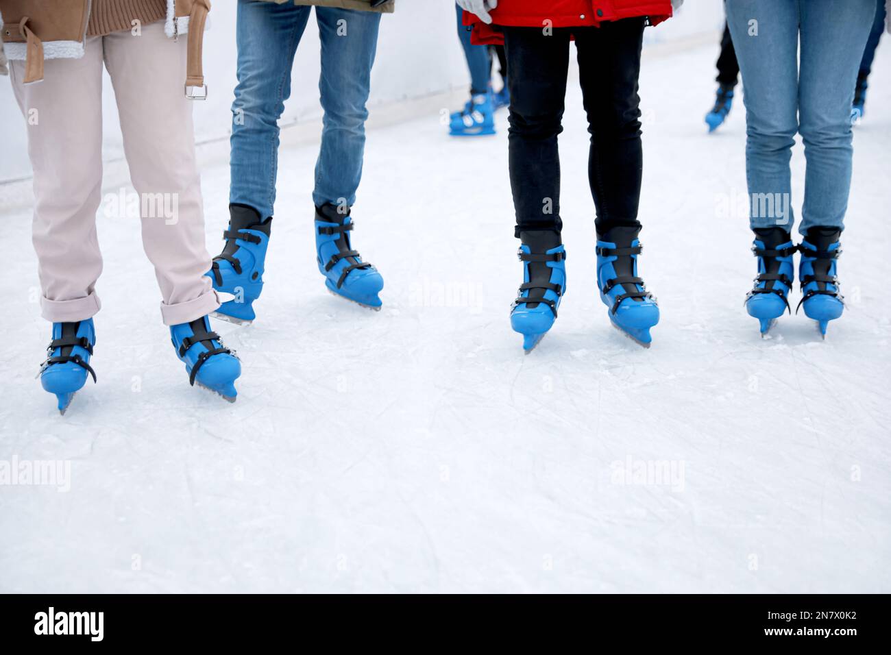 Group of friends skating at outdoor ice rink, closeup Stock Photo - Alamy