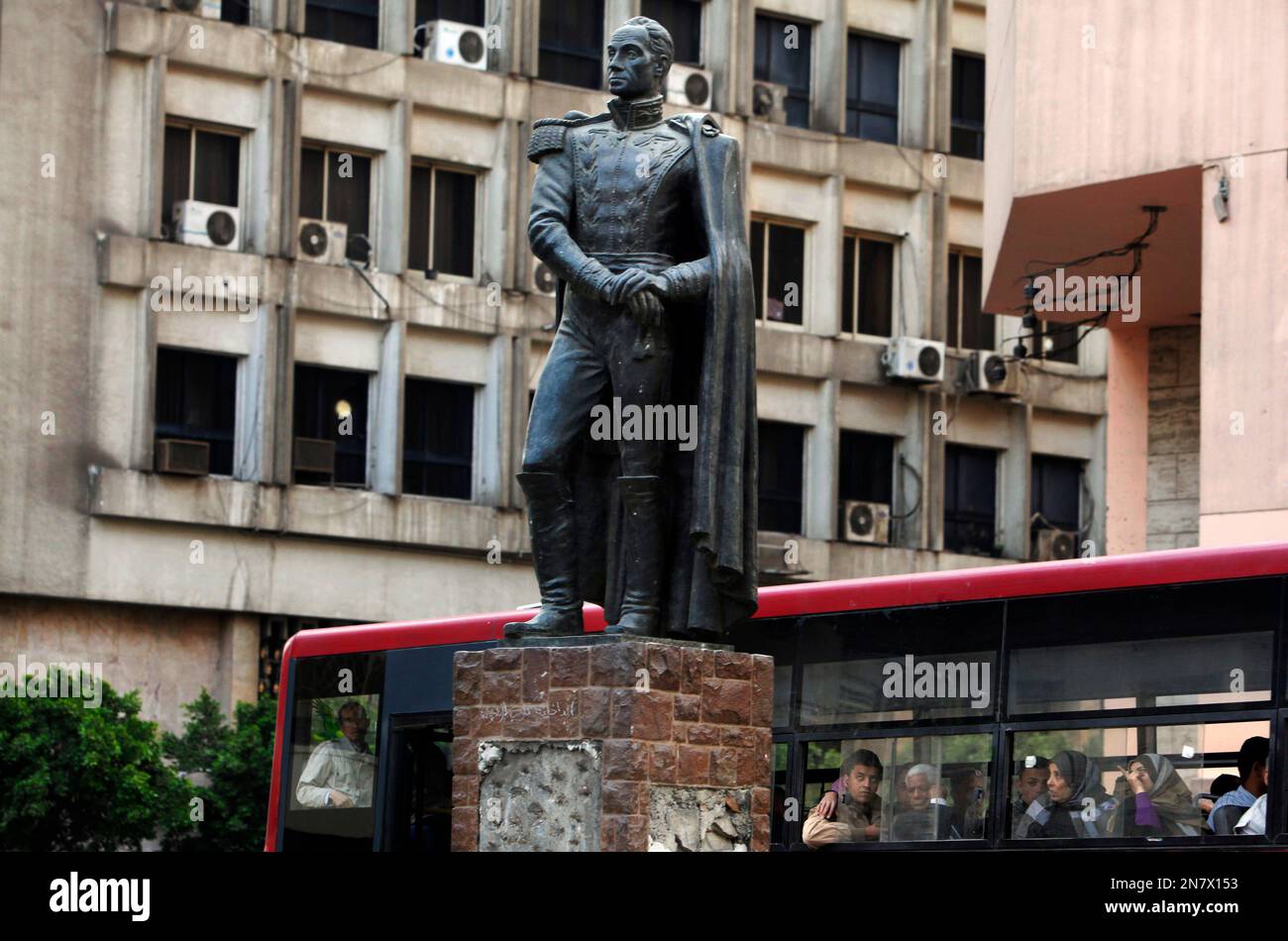 Egyptians look at the statue of South American independence leader ...