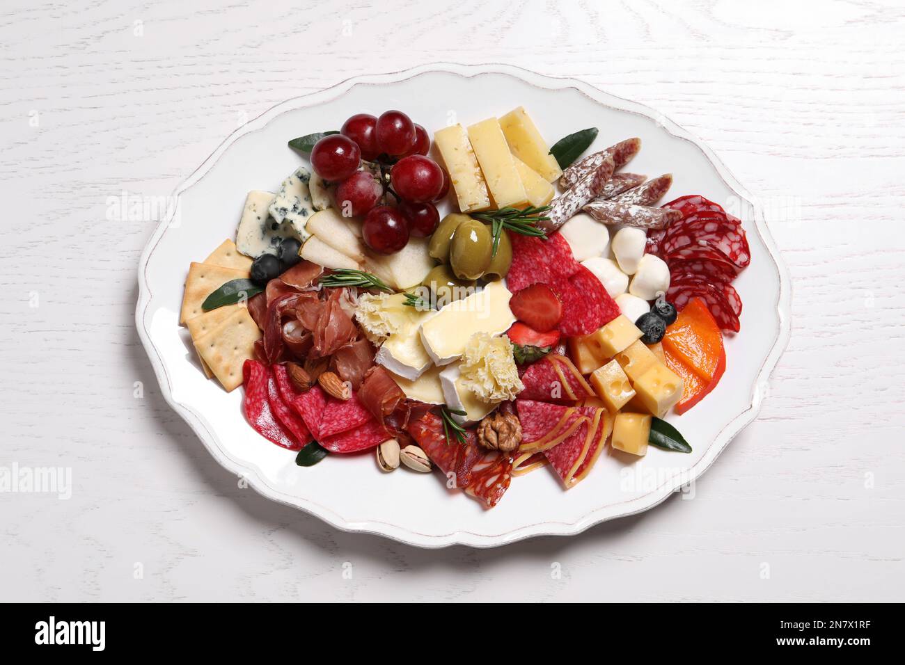 Assorted appetizers served on white wooden table, top view Stock Photo ...