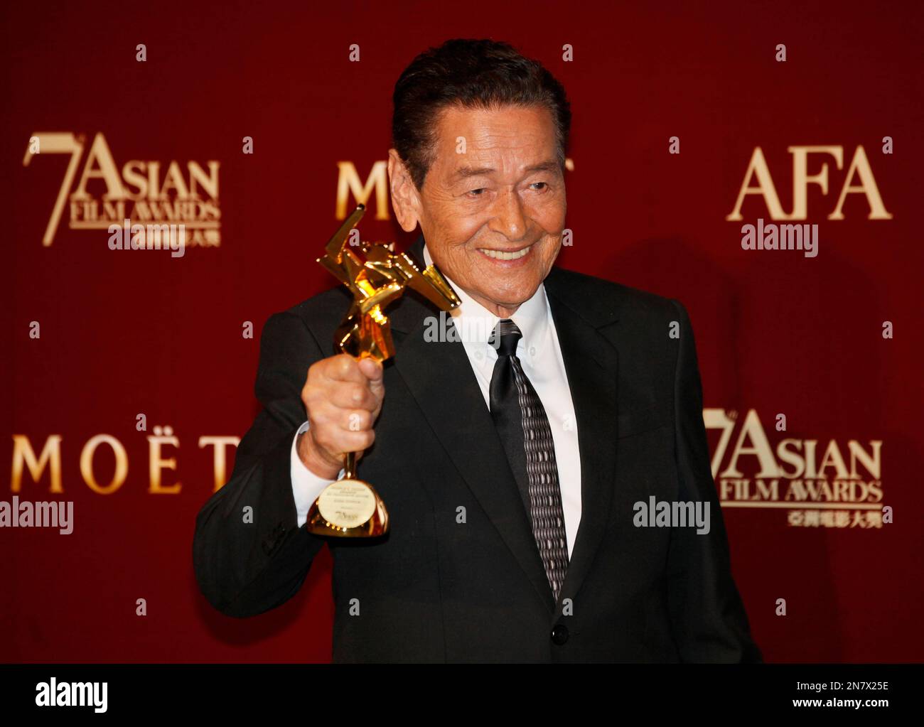 The Philippines actor Eddie Garcia poses with his trophy after winning ...