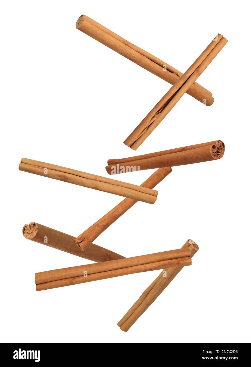 Aromatic cinnamon sticks falling on white background Stock Photo - Alamy