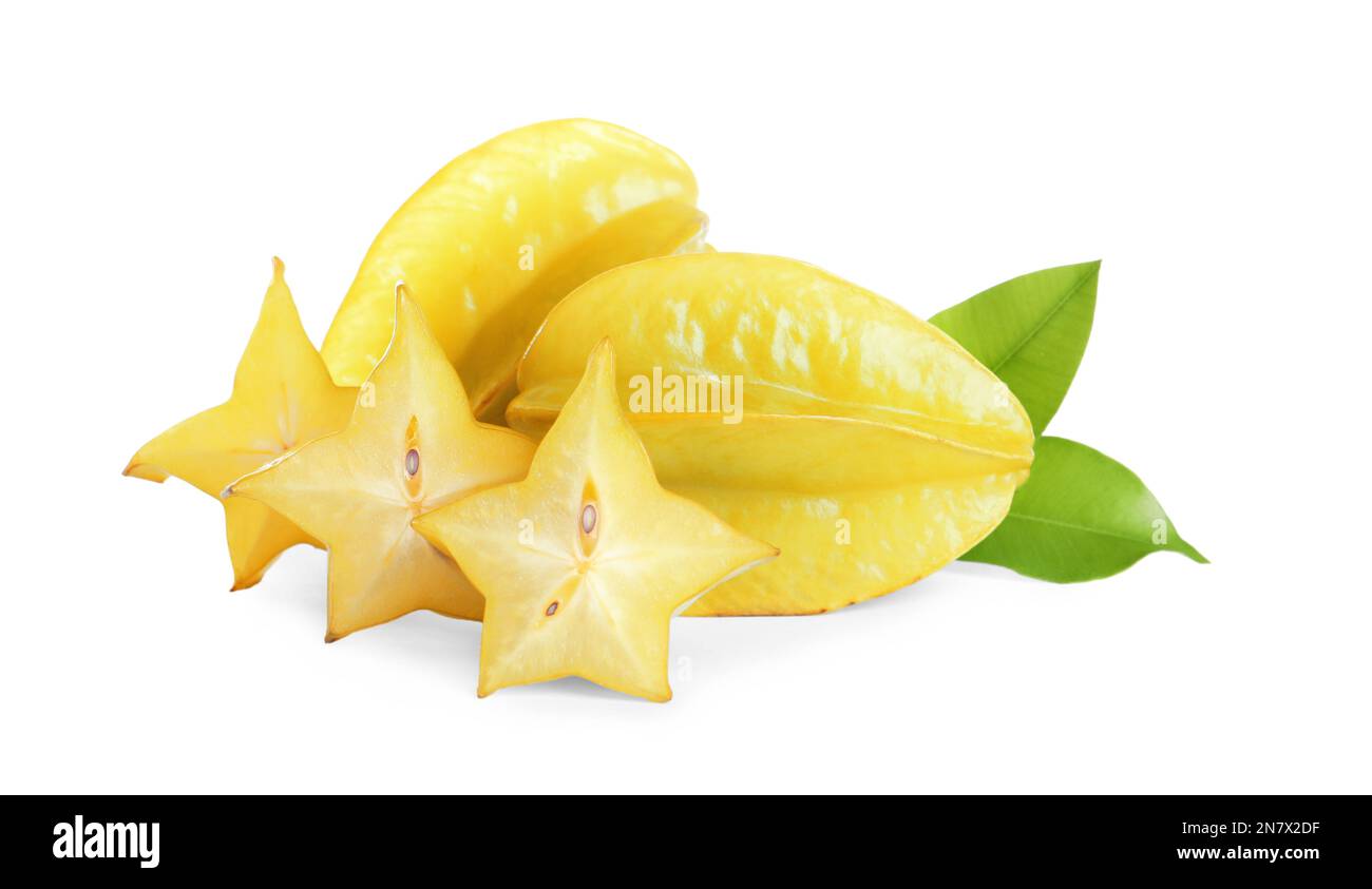 Cut and whole carambolas with green leaves on white background Stock ...