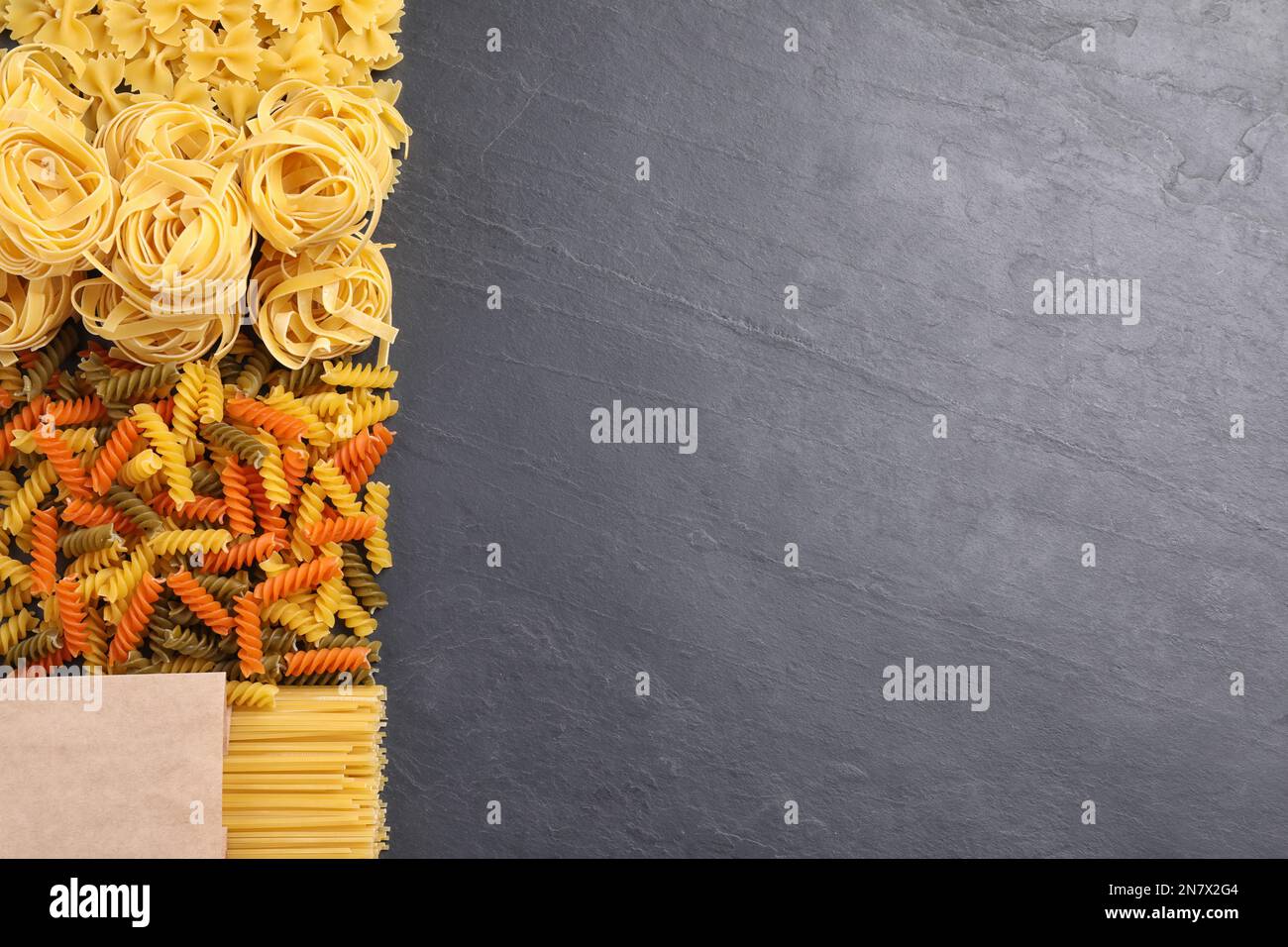 Different types of pasta on grey table, flat lay. Space for text Stock ...