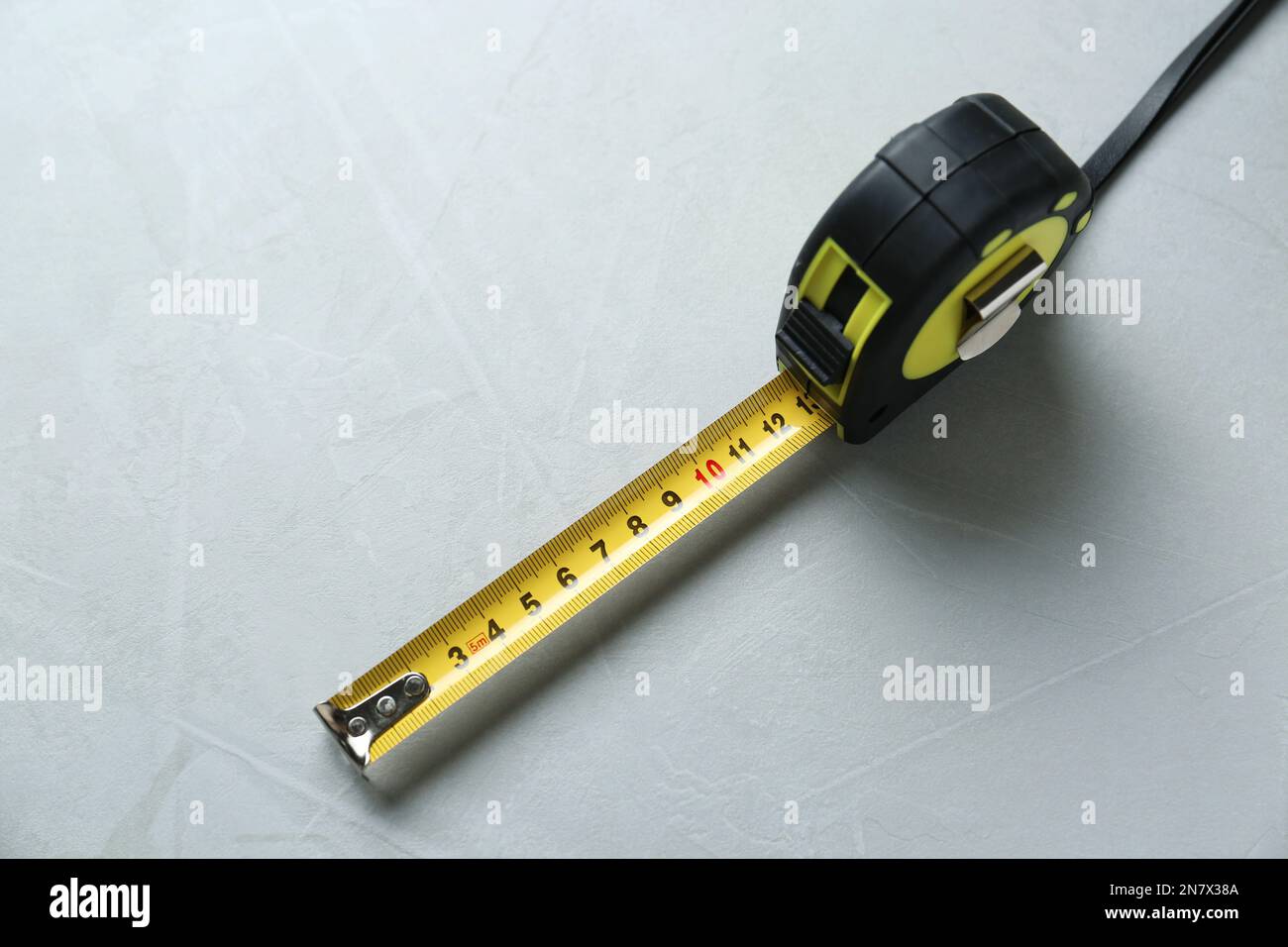 Tape measure on light grey background, above view. Construction tool ...