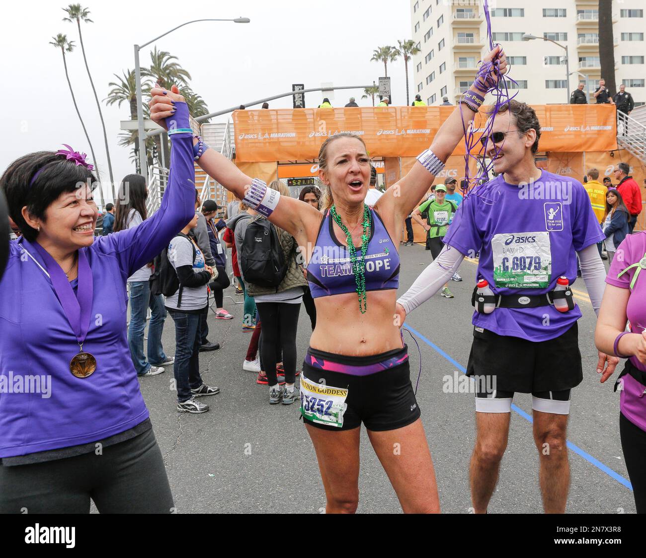 Julie Weiss, 42, center, with her fiancee David Levine, right, and six ...