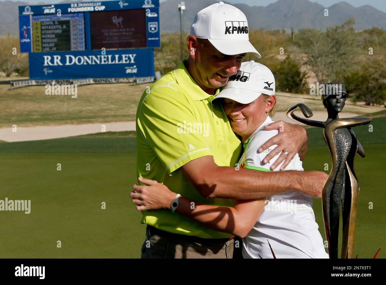 Stacy Lewis, right, gets a hug from her father, Dale Lewis, after she ...