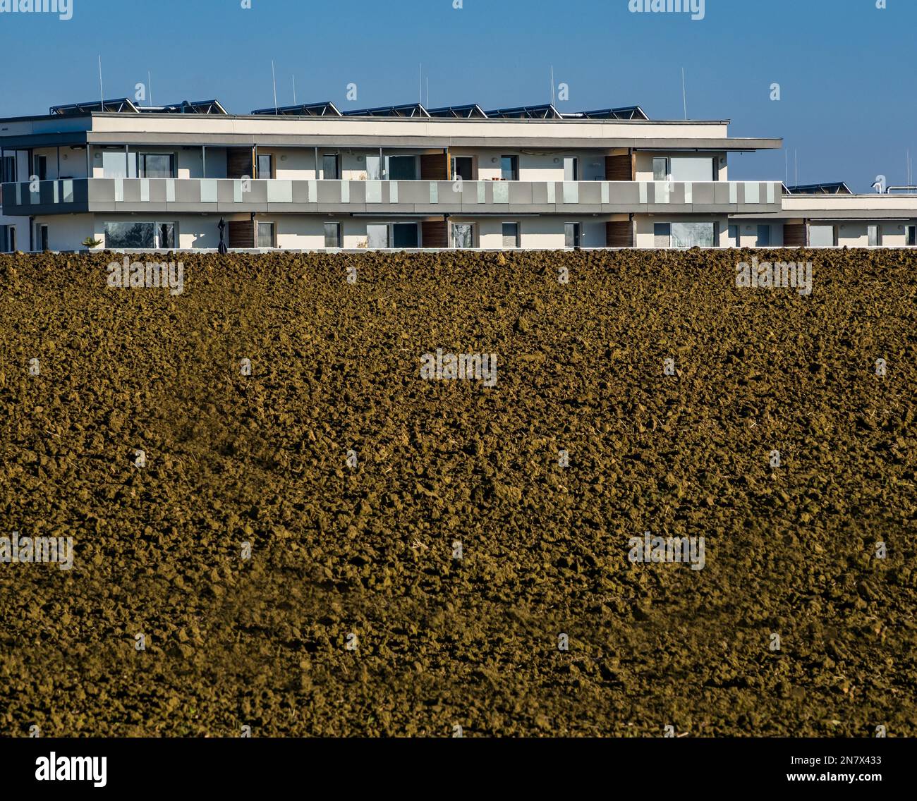 Newly built residential house in front of agricultural land. Symbol for ...